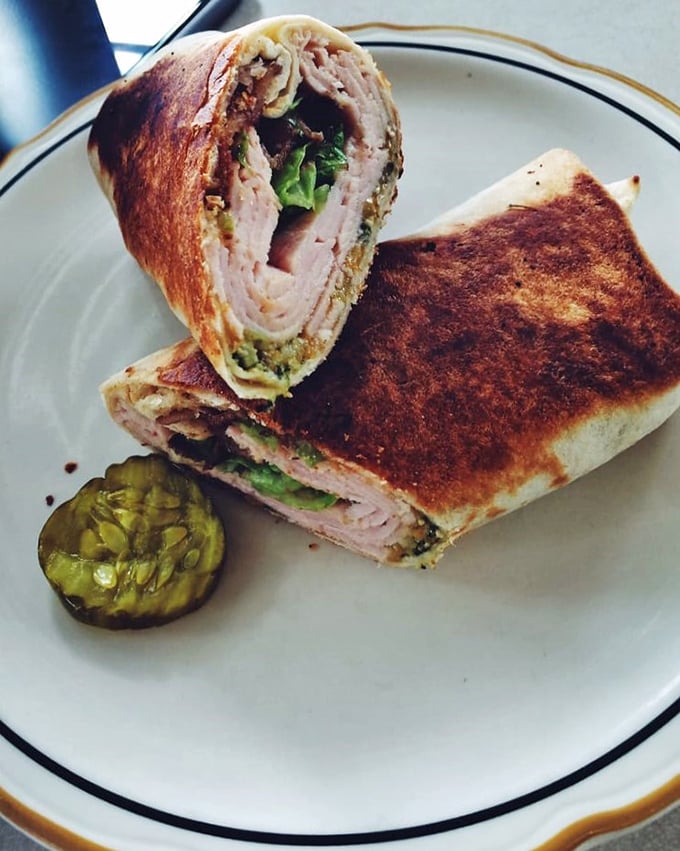 This isn't just a sandwich; it's architectural genius – layers of flavor stacked with the precision of a Jenga master who really understands lunch.