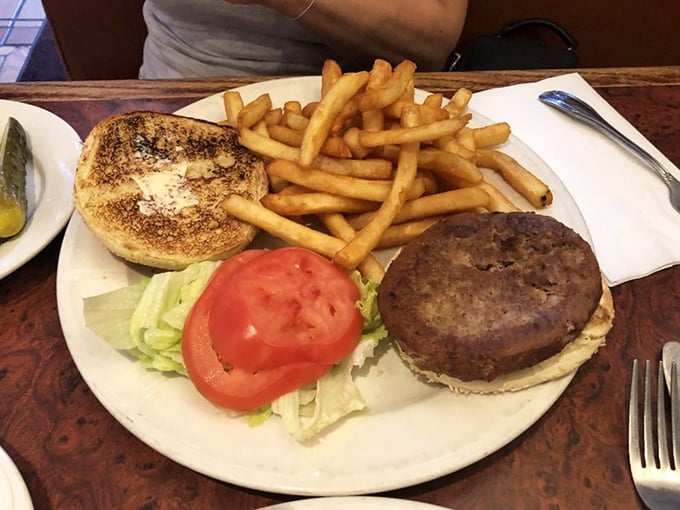 The classic burger and fries combo—where the tomato slice is perfectly centered as if positioned by a food stylist with OCD tendencies.