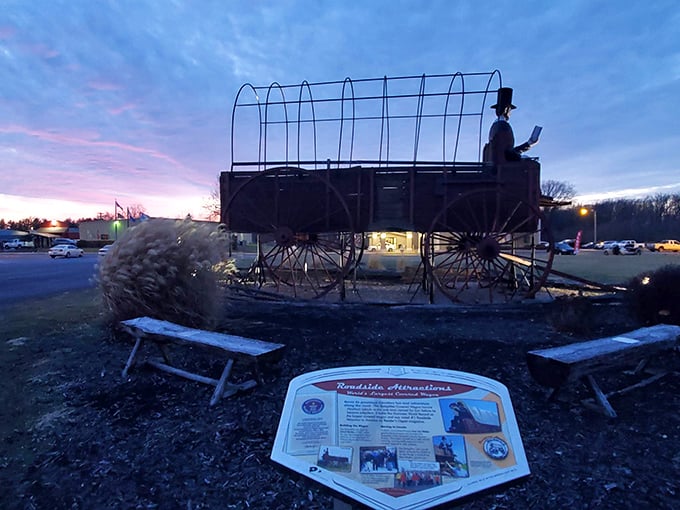Twilight transforms the wagon into a silhouette against the fading sky. Even the metal framework seems to whisper tales of westward expansion.
