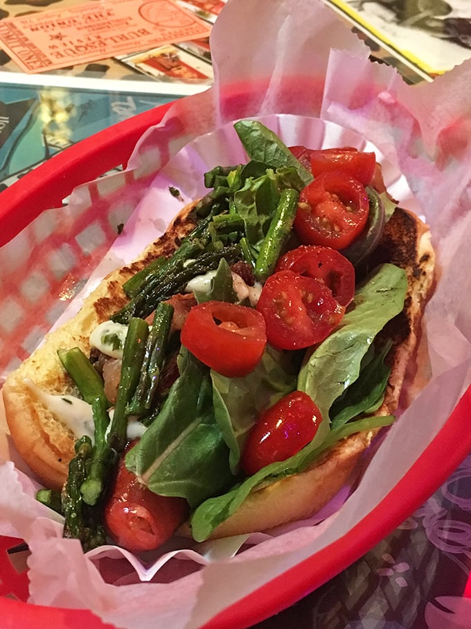 This isn't just a veggie dog – it's garden-fresh artwork on a bun. Those vibrant tomatoes and greens make even carnivores do a double-take.