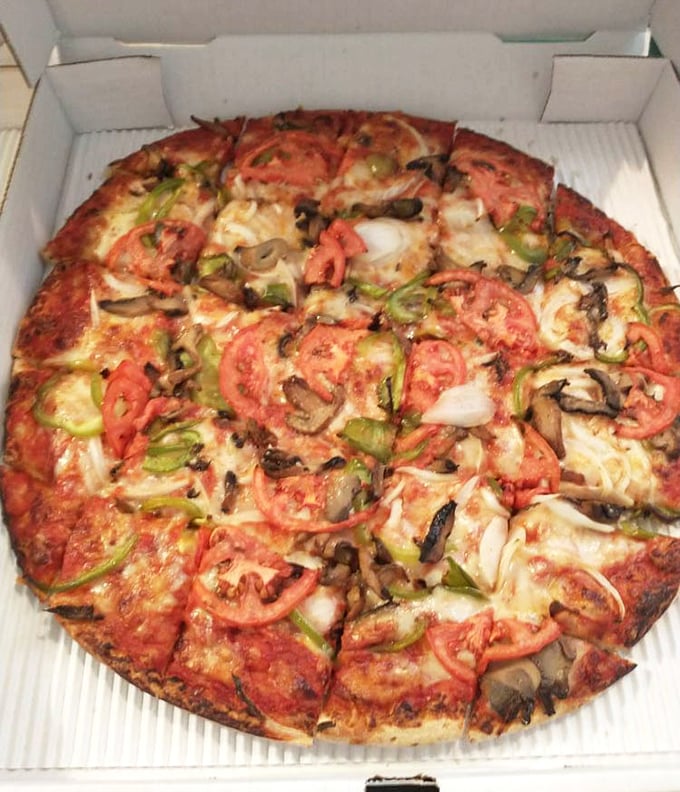 The veggie pizza proves that meatless doesn't mean joyless. Fresh tomatoes, mushrooms, and peppers create a garden of delights on that perfect crust.