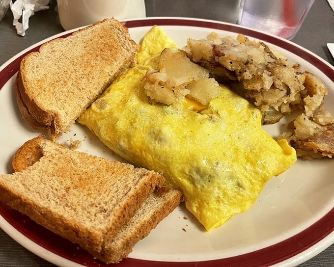 This omelet doesn't just contain ingredients—it showcases them, with hash browns crisped to that perfect golden-brown sweet spot.