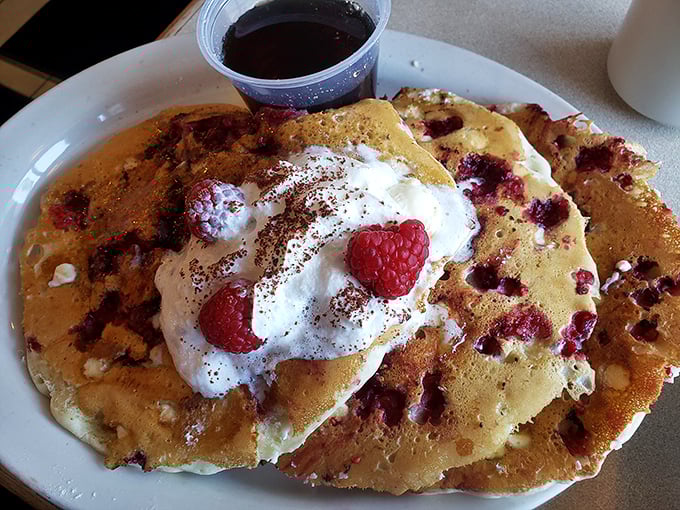These raspberry pancakes aren't just breakfast—they're an edible love poem topped with whipped cream and berries that would make Shakespeare put down his quill in defeat.