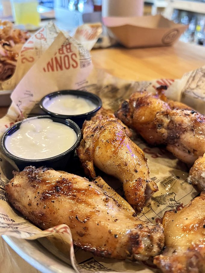 These wings aren't trying to reinvent the wheel—they're just showing the wheel how it's done, with a smoky twist and dipping sauces for days.