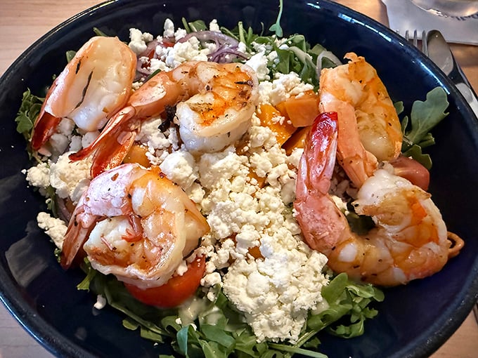 Grilled shrimp over fresh greens with crumbled cheese – proof that salads can actually be exciting dinner choices.