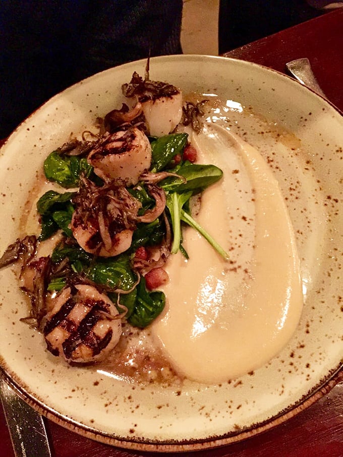 These scallops aren't just cooked—they're respected. Perfectly seared and nestled alongside vibrant greens, they're the ocean's candy.