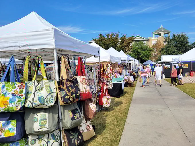 Colorful vendor tents line the walkway during market days—where "just browsing" becomes "somehow I bought four handmade beach bags."