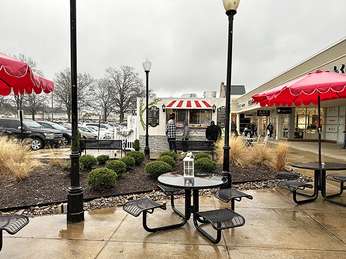 Outdoor seating areas provide strategic resting spots for weary shoppers. Those red umbrellas aren't just for shade—they're beacons of hope for tired feet.