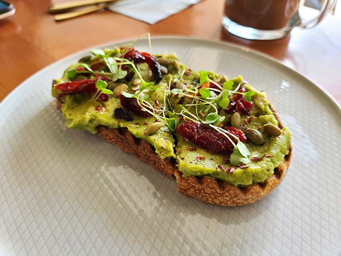Avocado toast that refuses to be basic. Those sun-dried tomatoes and microgreens aren't just garnish—they're supporting actors in a delicious drama.