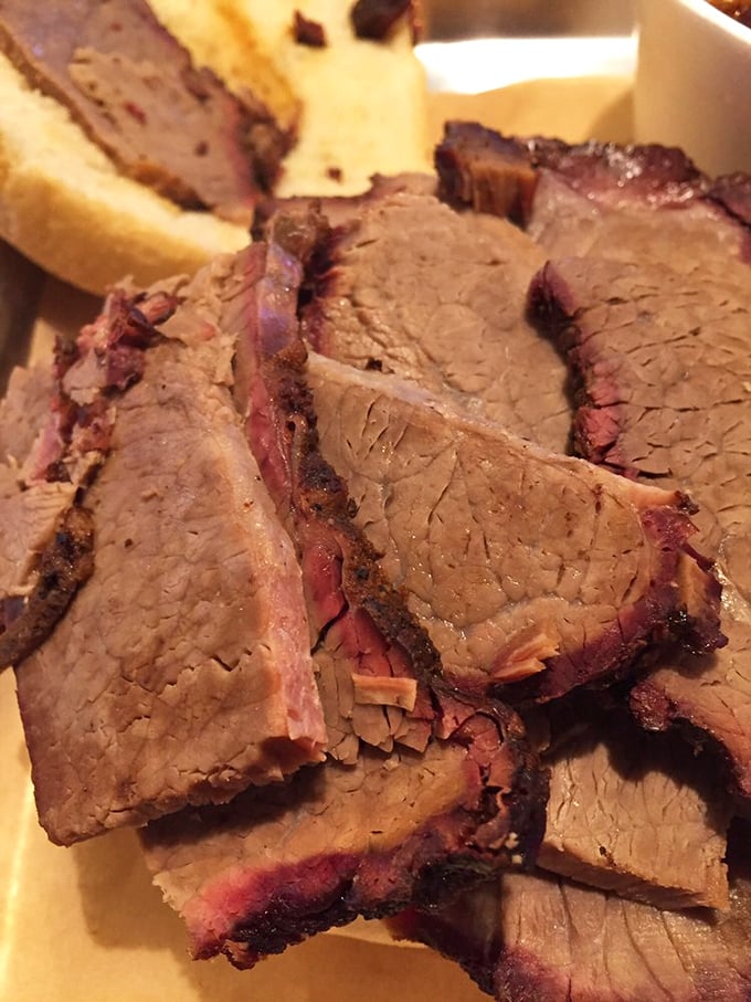Brisket sliced so perfectly you'd think it went to geometry class. That pink smoke ring is the barbecue equivalent of a Michelin star.