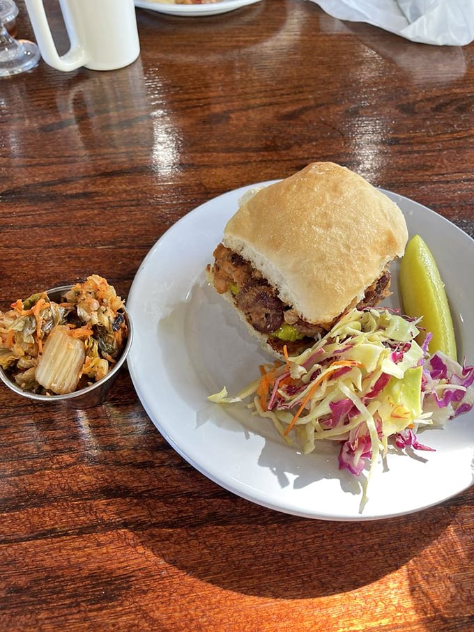 This sandwich isn't just lunch; it's architecture with purpose—stacked high with fresh ingredients and paired with a rainbow slaw that means business.