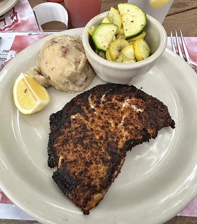 Blackened to perfection with a caramelized crust giving way to flaky white fish. The mashed potatoes aren't just a side—they're a co-star.