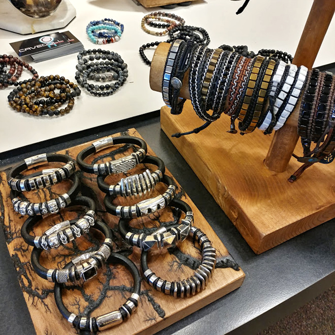 Handcrafted bracelets lined up like soldiers, each one promising to be that conversation piece that makes strangers ask, "Where did you find that?"