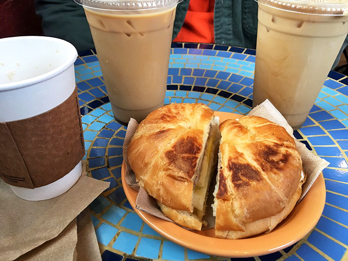 Breakfast sandwich perfection on a golden croissant—proof that mornings don't have to be awful if you start them with butter-laden carbs and coffee.