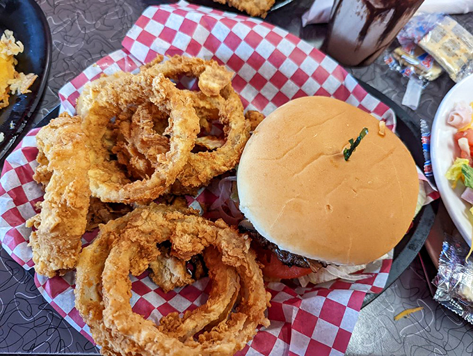 Those onion rings aren't just sides—they're main attractions with a burger chaperone. Crispy, golden, and unapologetically indulgent.