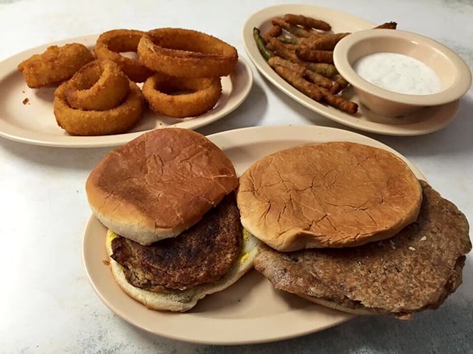 These doughburgers with their distinctive texture tell the story of Depression-era ingenuity, served with onion rings that could make a food snob weep with joy.