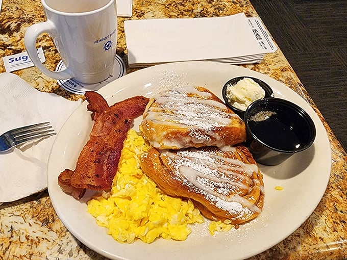 French toast that makes you question every other breakfast decision you've ever made—dusted with powdered sugar and served with a side of morning bliss.