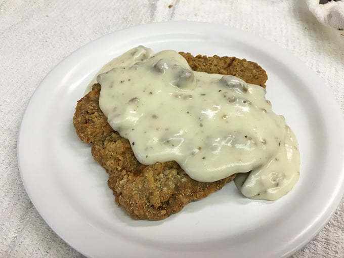Country fried steak smothered in creamy sausage gravy—a dish so good it should require a permission slip from your doctor.