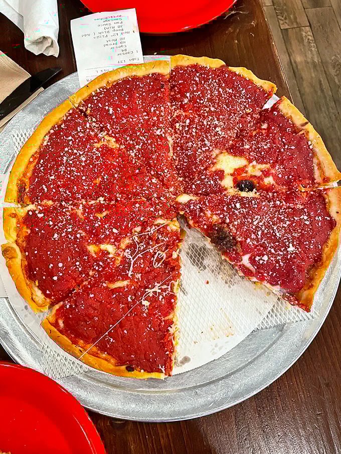 Chicago-style pizza that doesn't mess around—a serious pie with that distinctive red sauce proudly sitting on top like it owns the place.