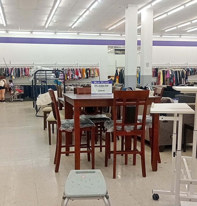 A dining set stands ready for inspection, while clothing racks create a colorful backdrop – home and fashion coexisting in thrift harmony.