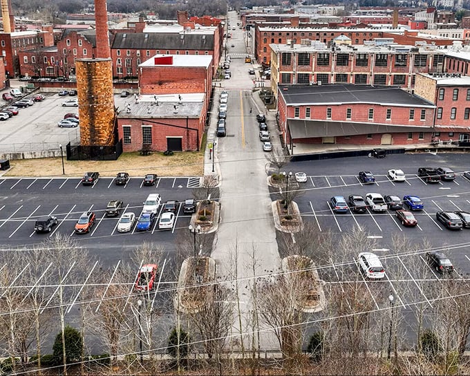 Former textile mills stand as brick sentinels overlooking parking lots where factory workers once clocked in for shifts.