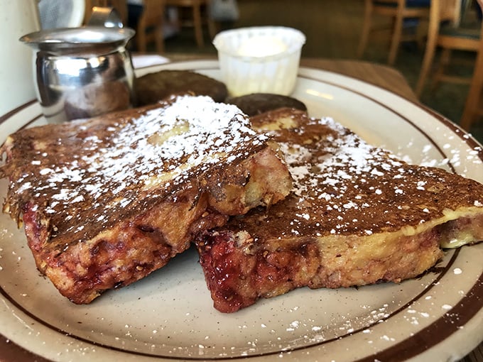 French toast dusted with powdered sugar like fresh Minnesota snow, thick slices that laugh at those thin restaurant imposters.
