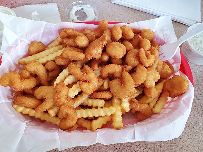 Golden-fried shrimp nestled among crinkle-cut fries—a match made in comfort food heaven. The kind of meal that makes you forget your diet resolutions.