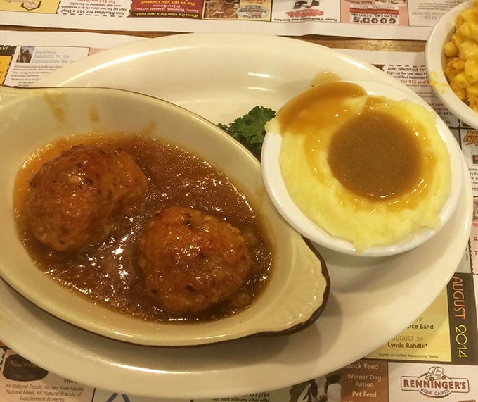 Ham balls swimming in glaze beside a crater of mashed potatoes—proof that Pennsylvania Dutch cuisine knows comfort food isn't just a meal, it's a warm hug on a plate.