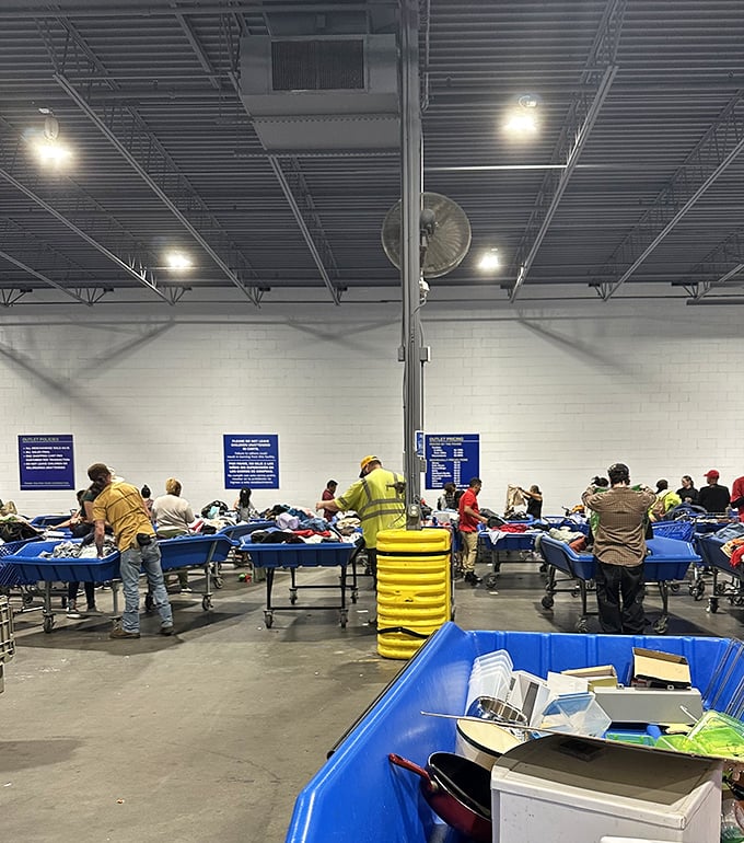The thrill of the hunt in action – shoppers strategically positioned around blue bins, each focused with the intensity of gold miners panning for that perfect nugget.