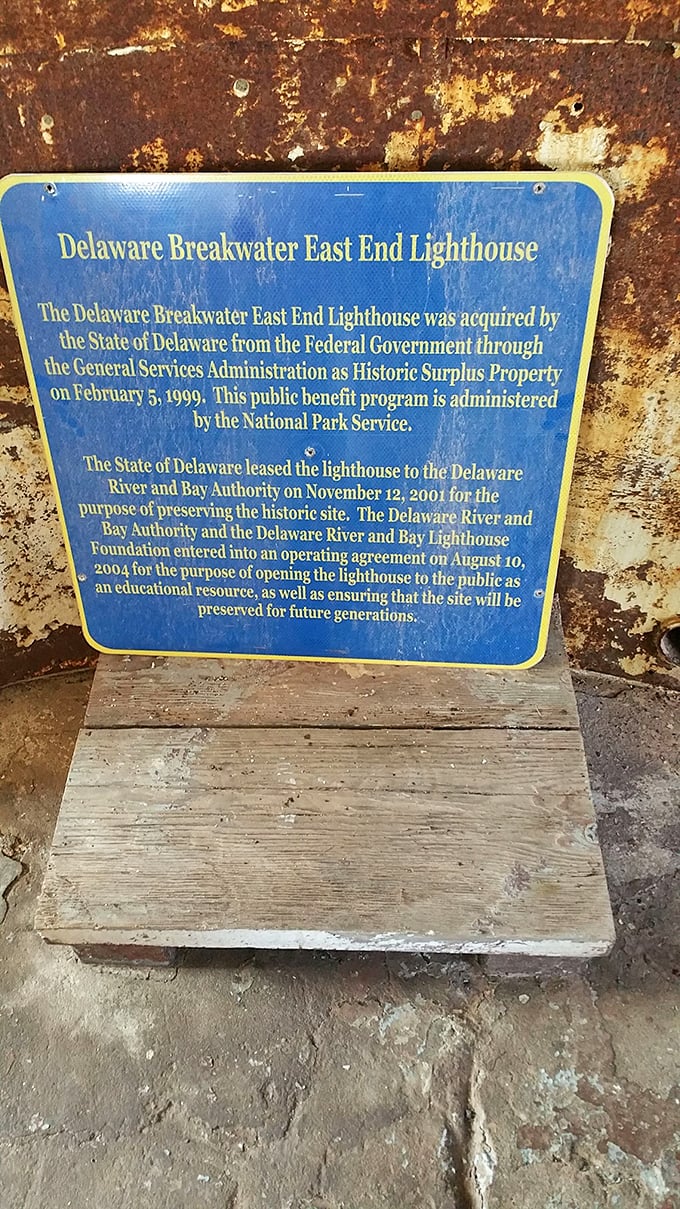 History preserved in blue and rust. This weathered plaque tells the tale of how a federal lighthouse found new life as Delaware's maritime crown jewel.