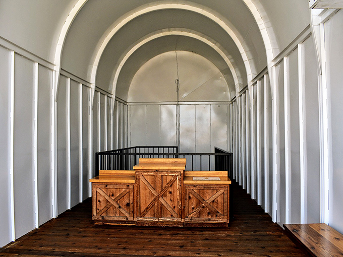 Inside, the mailbox's gleaming white interior houses wooden crates that seem to ask, "What would you mail if size were no object?"