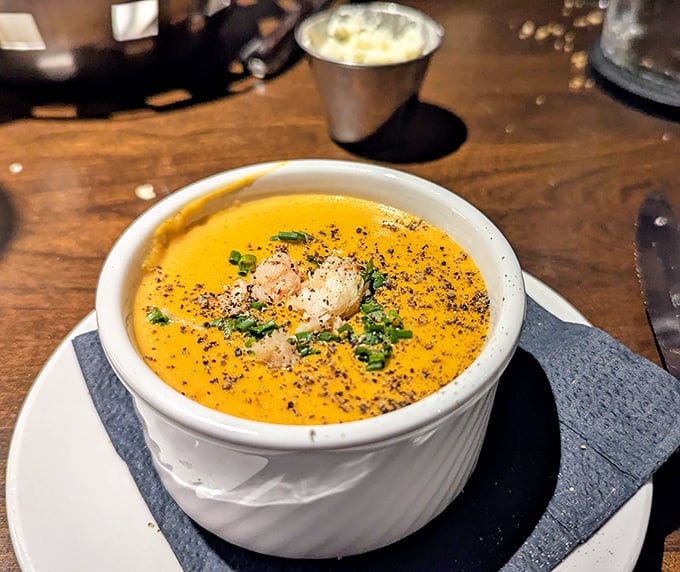 A velvety lobster bisque that whispers of the sea, garnished with delicate seafood morsels and fresh herbs – comfort in a bowl.