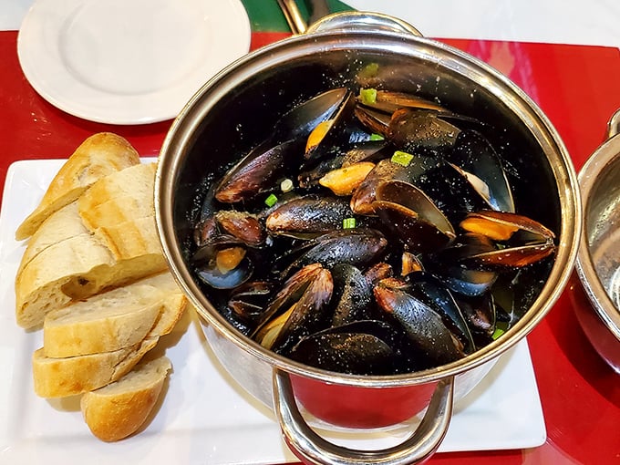 Steamed mussels in their gleaming pot with crusty bread alongside—a simple pleasure that transcends geography and speaks the universal language of delicious.