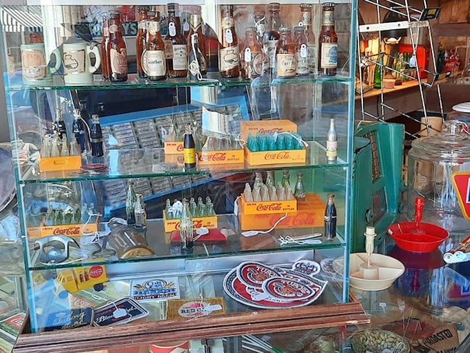 Vintage Coca-Cola bottles and advertising memorabilia—when soda came in glass and logos were works of art.