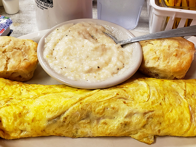 Breakfast doesn't get more honest than this – a fluffy omelet that practically floats, grits creamier than a love song, and biscuits that could end family feuds.