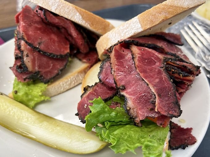 The pastrami sandwich – where pepper-crusted meat meets bread in a relationship more passionate than any romance novel.
