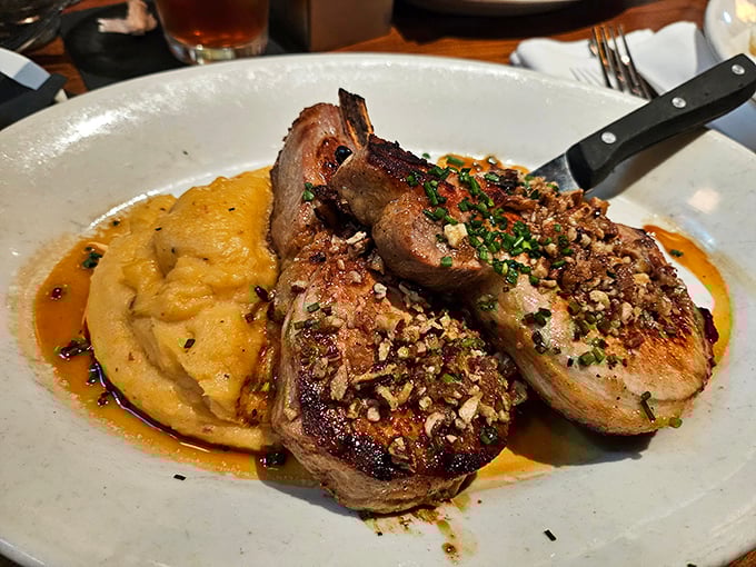 These pork chops aren't just cooked, they're pampered—crusted to perfection and served alongside creamy mashed potatoes that could make a Frenchman weep.