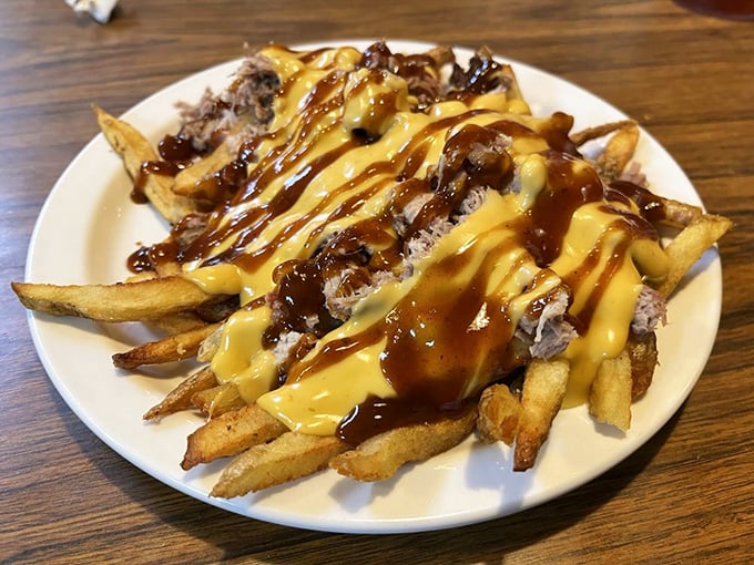 Behold the pig fries—where French fries meet pulled pork, cheese sauce, and barbecue drizzle in a glorious union that should probably be illegal.