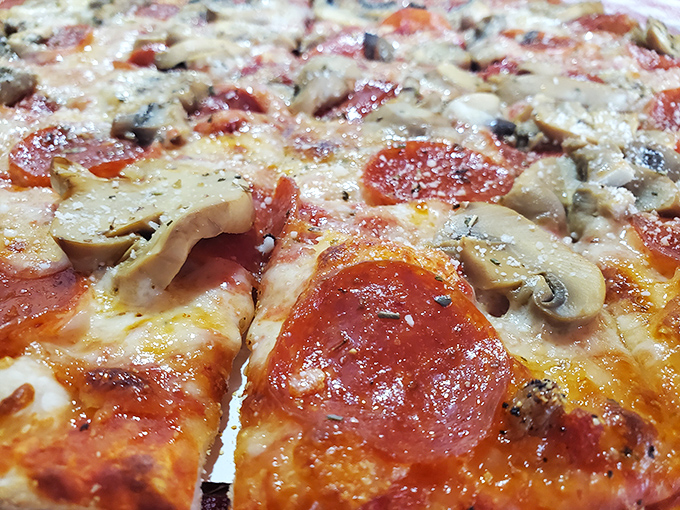 Even the pizza at a barbecue joint deserves respect—loaded with toppings and that perfect cheese pull that makes you temporarily forget you came for the smoked meats.