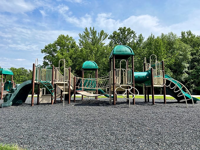 A playground where kids can burn energy while parents secretly envy the simplicity of childhood joy—swinging, sliding, and zero emails to check.