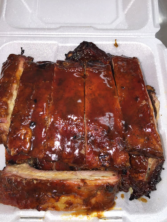 These ribs don't just fall off the bone—they practically leap onto your fork, glistening with a sauce that balances sweet, tangy, and smoky notes.