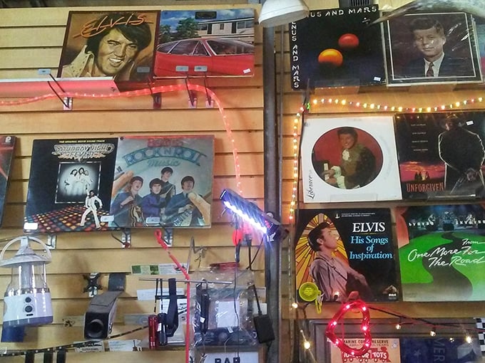 The wall of vinyl records and memorabilia serves as a time capsule of American pop culture—Elvis hasn't left this building.
