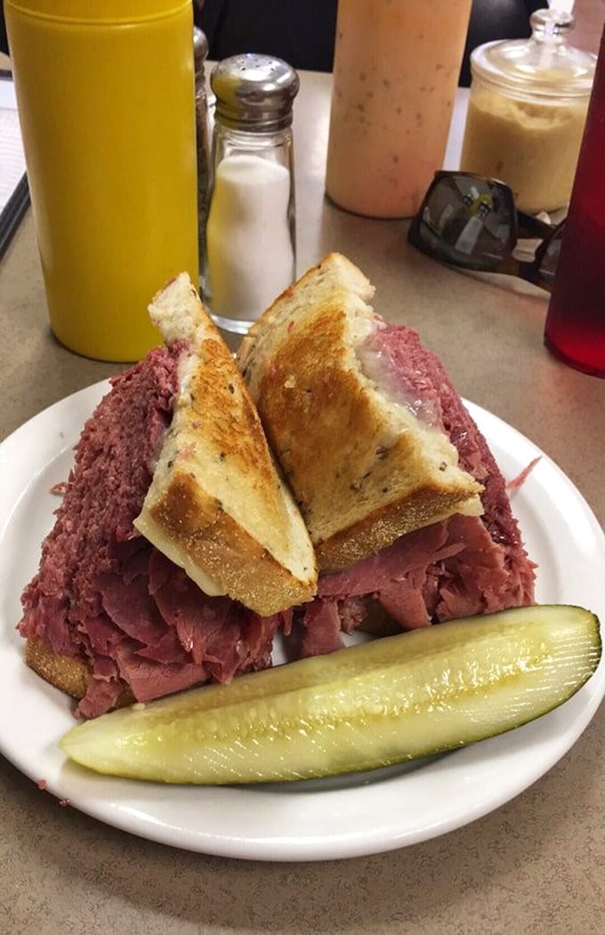 Behold the Reuben in its natural habitat – where Swiss cheese, sauerkraut and Russian dressing perform a harmonious dance with corned beef.