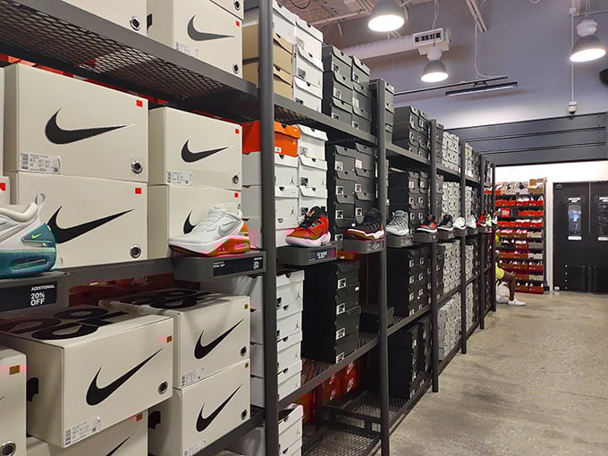 The Nike outlet's wall of shoe boxes resembles a retail Tetris game, each container holding potential athletic greatness—or at least the appearance thereof.