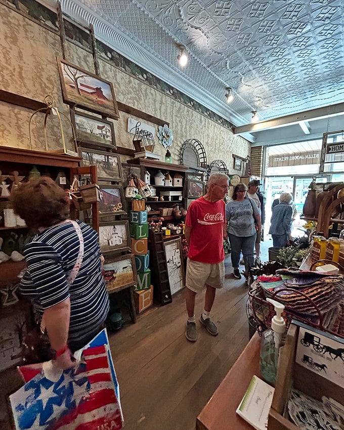 Treasure hunters navigate narrow aisles beneath that spectacular tin ceiling, each person's expression revealing the universal thrill of the hunt.