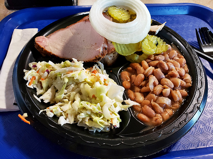 A perfect barbecue trinity – tender ham, creamy coleslaw, and pinto beans that have been simmering since dawn. Simple pleasures, profound satisfaction.