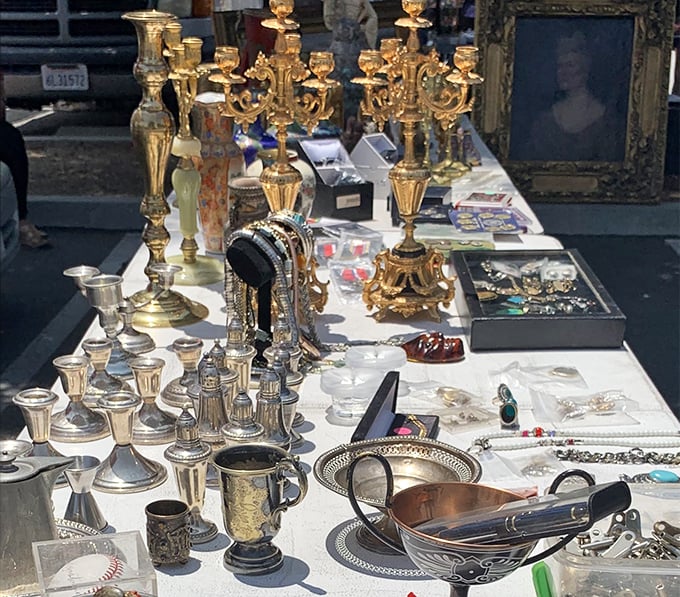 Gleaming candelabras and silver treasures catch the morning light, each piece whispering stories of elegant dinner parties and bygone eras.