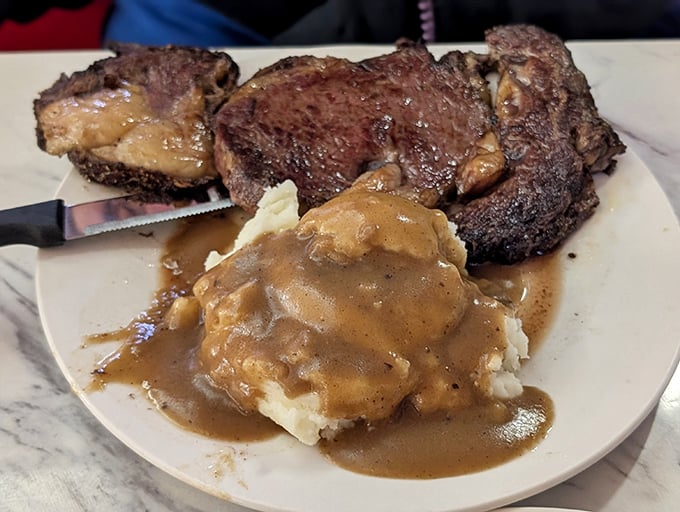 This isn't just meat and potatoes—it's a carnivore's dream with gravy-smothered mashed potatoes that your grandmother would approve of.
