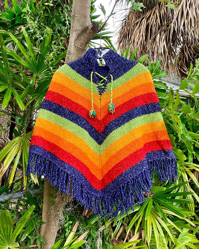 Not just any poncho—a rainbow time machine to the 1970s. Perfect for those three days of Florida "winter" or your next music festival.