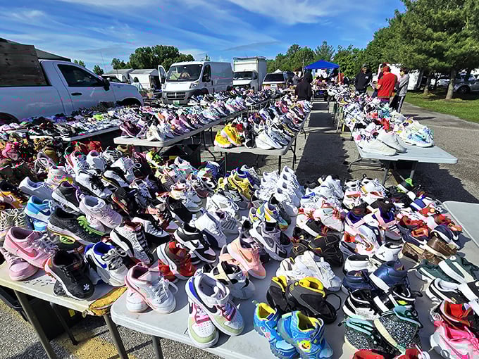 Tables overflow with sneakers in every color imaginable, creating a rainbow of footwear options for deal-seeking shoppers.